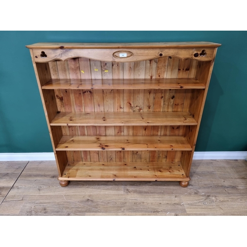 A modern pine open Bookcase with adjustable shelves raised on bun feet 4ft 1in W x 4ft 1in H (R7)