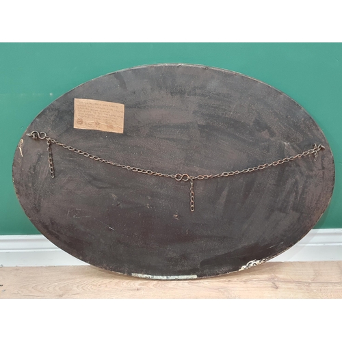 An oval copper framed Wall Mirror with applied shell type roundel ...