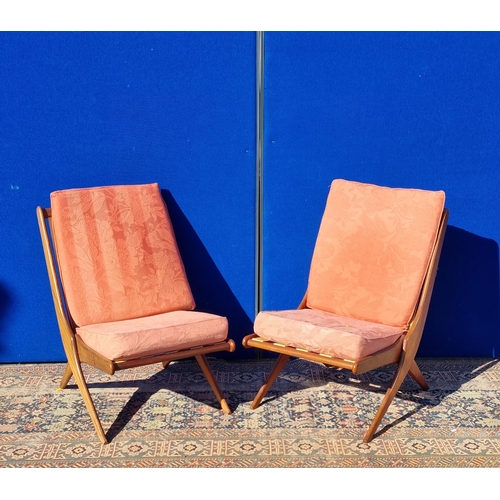 A pair of mid-Century Reyway Chairs, with loose cushions, bearing the ...