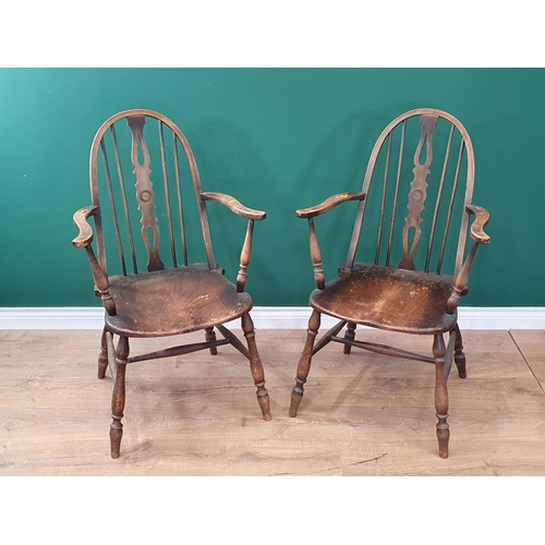 A pair of elm and beech Windsor type Elbow Chairs raised on turned ...
