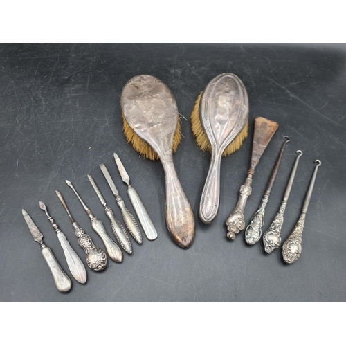 Two silver mounted Brushes and a quantity of silver handled Button ...