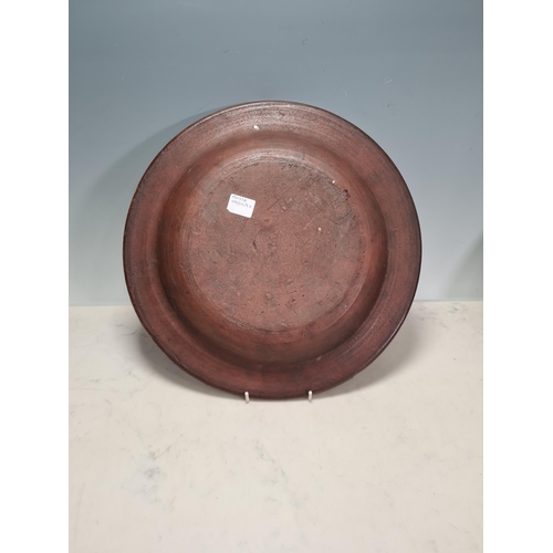 A slipware Charger decorated with Figure and Flowers and bearing the ...