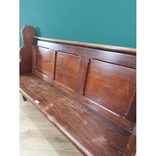A pitch pine Pew with panelled back and shaped supports 4ft 10in W, (R6)
