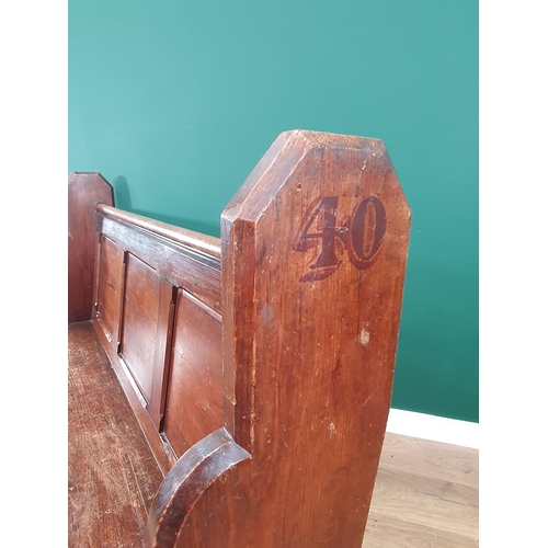 A pitch pine Pew with panelled back and shaped supports 4ft 10in W, (R6)