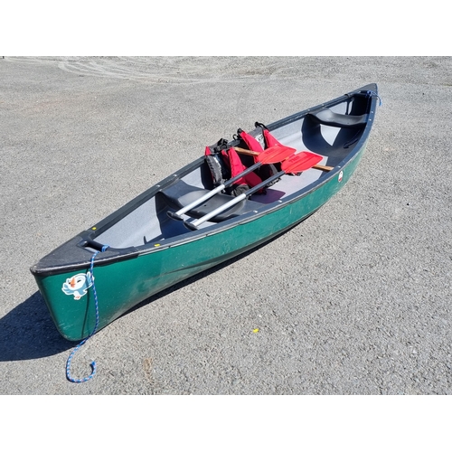 A Patagonia two Seater Canoe in green, with two paddles and two Palm ...