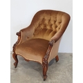 A Victorian button upholstered Easy Chair, with carved scroll and ...