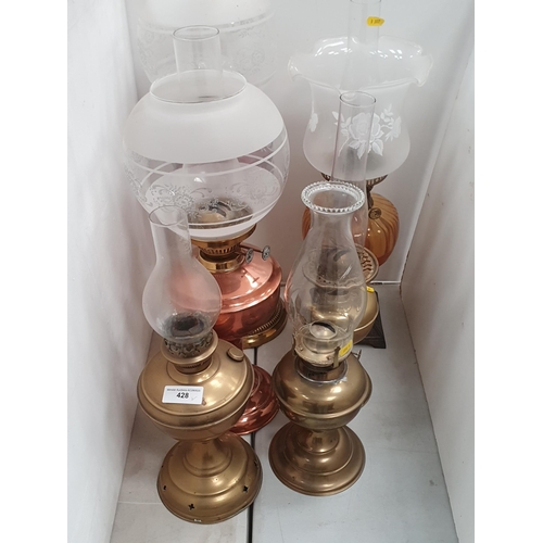 A Victorian brass Paraffin Lamp with cranberry glass reservoir and ...