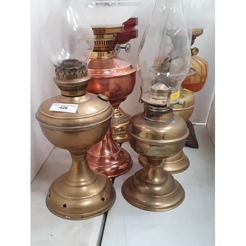 A Victorian brass Paraffin Lamp with cranberry glass reservoir and ...