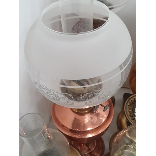 A Victorian brass Paraffin Lamp with cranberry glass reservoir and ...