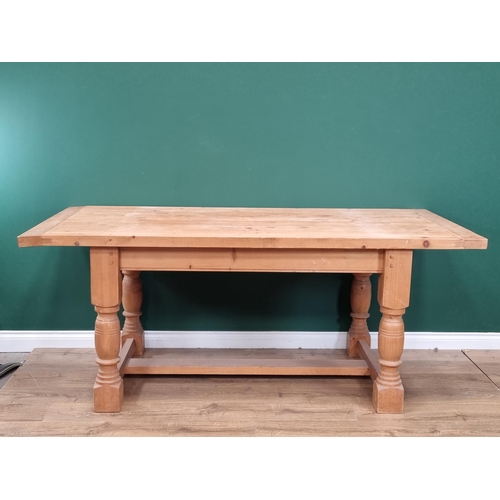 A large pine Dining Table with cleated top (one cleat loose), raised on ...
