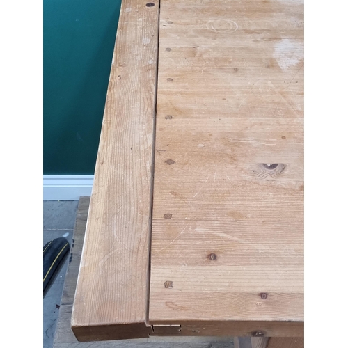 A large pine Dining Table with cleated top (one cleat loose), raised on ...