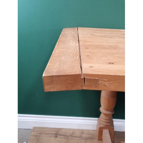 A large pine Dining Table with cleated top (one cleat loose), raised on ...