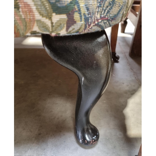 A button upholstered Easy Chair having a floral design on short ...