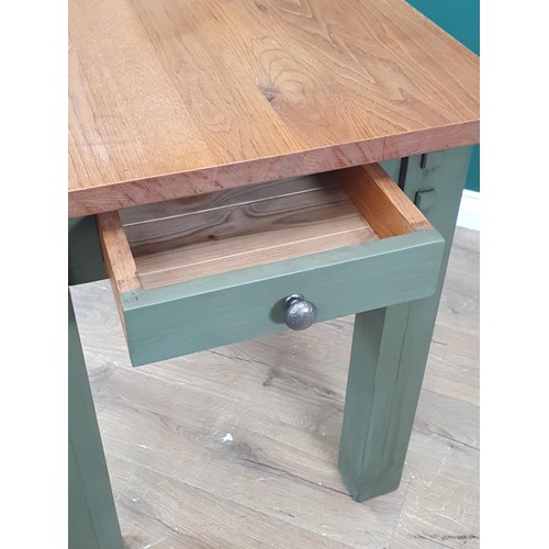 A modern oak Kitchen Table with green painted square supports, with ...