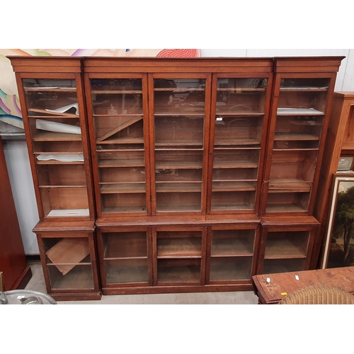A large oak inverted glazed breakfront Bookcase the top with moulded ...