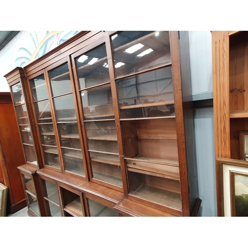 A large oak inverted glazed breakfront Bookcase the top with moulded ...