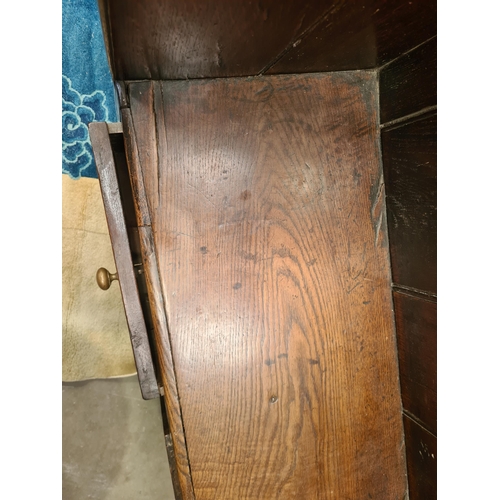 An 18th Century small oak wingback Settle fitted two drawers below the ...