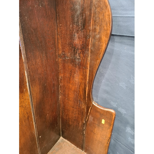 An 18th Century small oak wingback Settle fitted two drawers below the ...