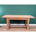 A large pine Dining Table with cleated top (one cleat loose), raised on ...