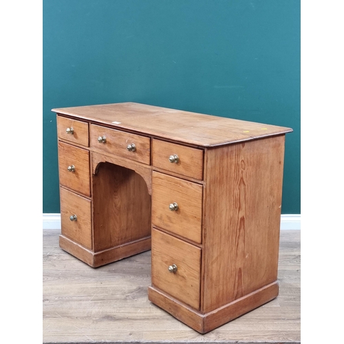A pine Kneehole Desk fitted six drawers and raised on plinth bases, 2ft ...