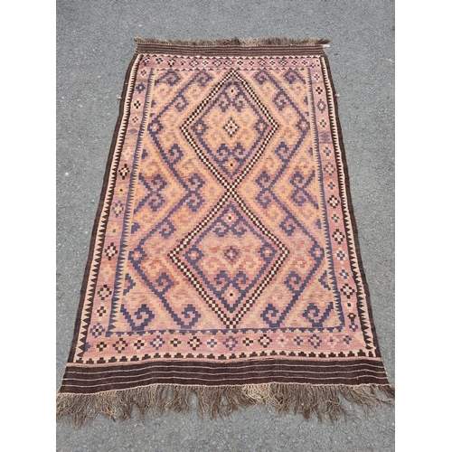 A Turkish Rug with large double lozenge design, with geometric designs ...