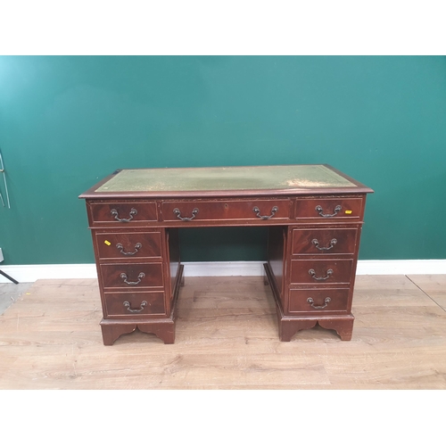 A reproduction mahogany pedestal desk fitted nine drawers raised on ...