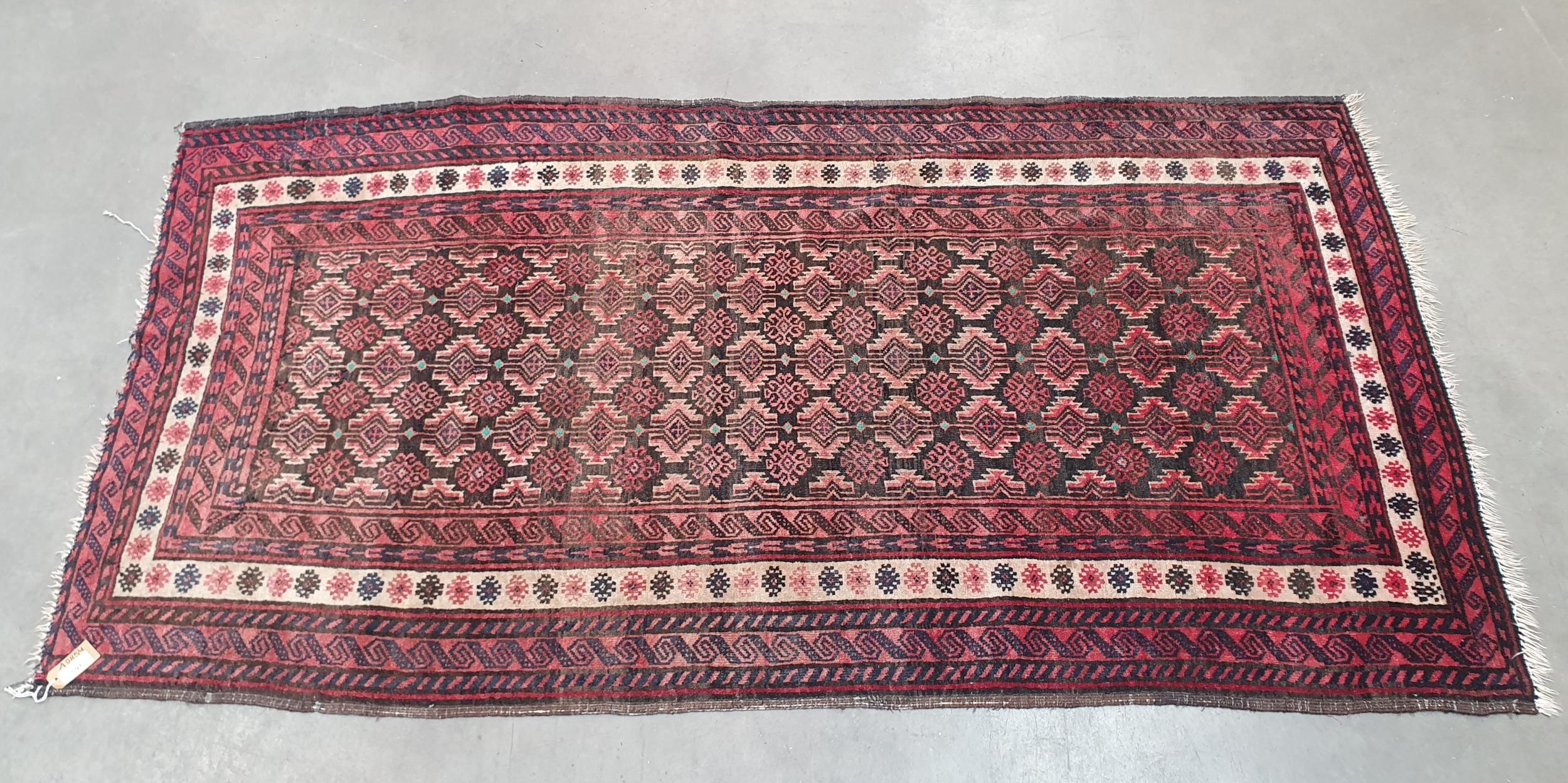 An Afghan Rug of multi-border design with rows of stylised motifs on a ...