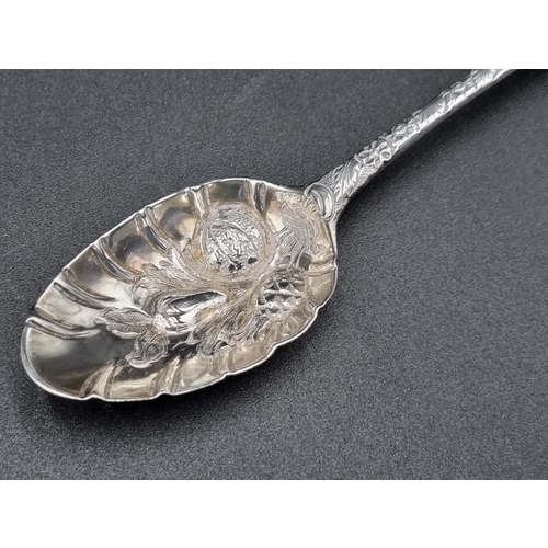 A Georgian silver Serving Spoon with fruit embossed bowl and scroll ...