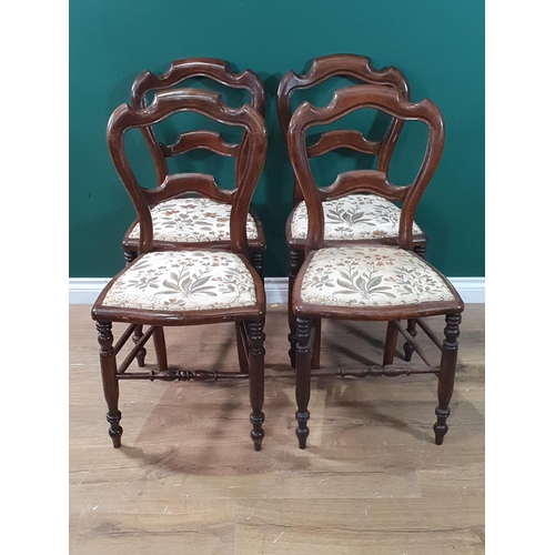 A set of four spoon back dining chairs raised on turned shaped supports ...
