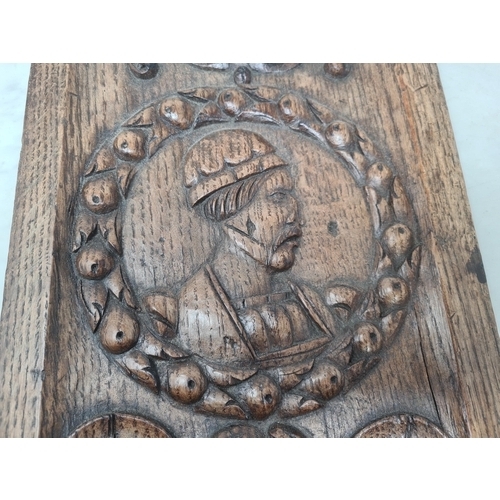 An early oak Panel carved central bust within circular cartouche ...