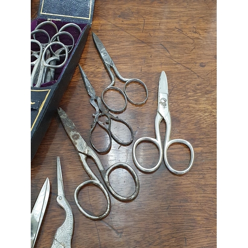 A collection of Scissors some in leather cases, an empty black Case ...