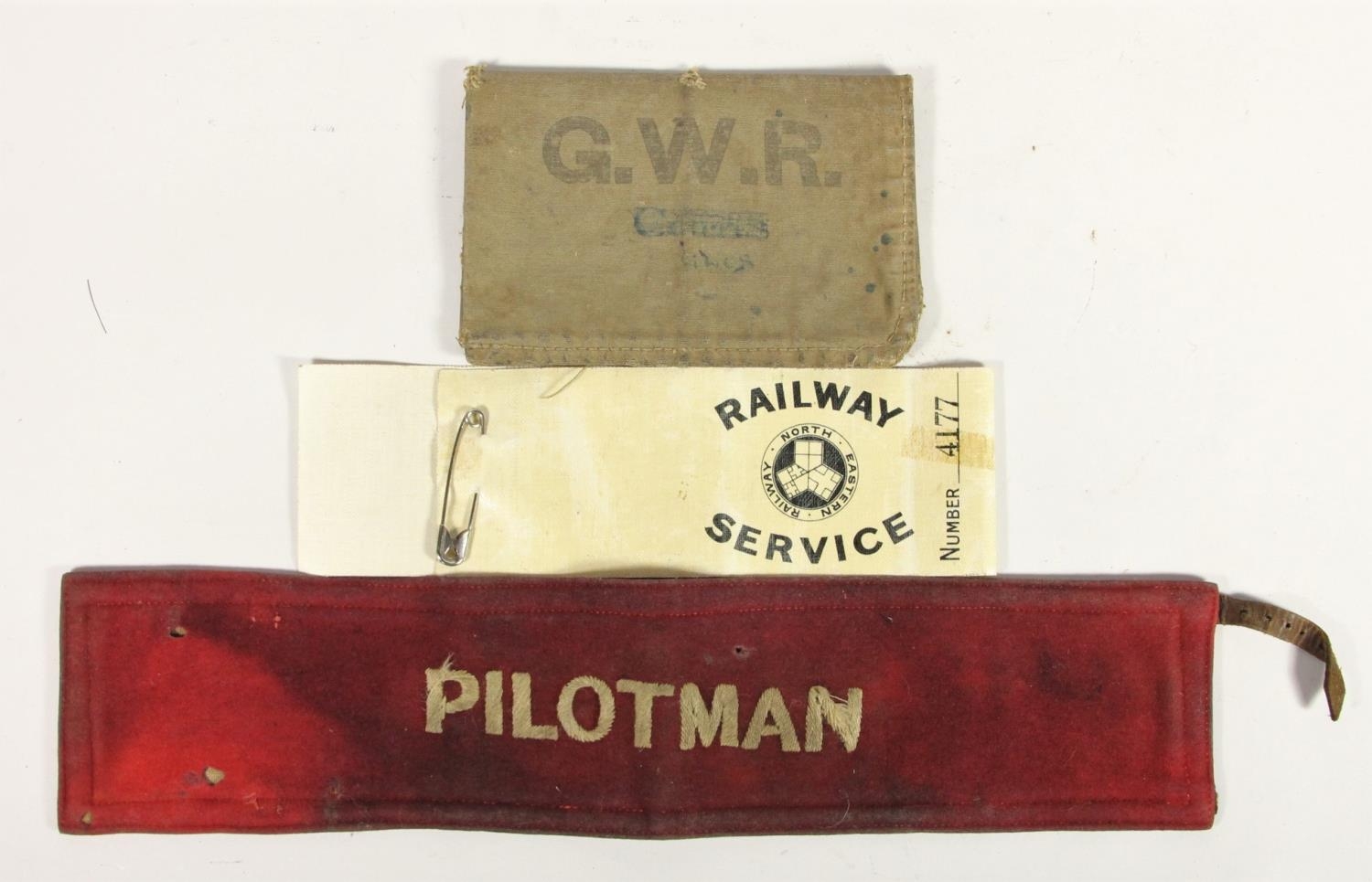 A Caledonian Railway cloth armband 'Pilotman', an N.E.R service armband ...