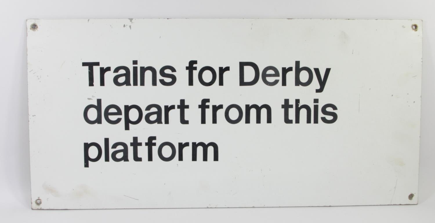 A modern metal station sign, Trains for Derby depart from this platform ...