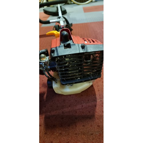 A Homelite Mighty Lite petrol garden strimmer, together with a ...