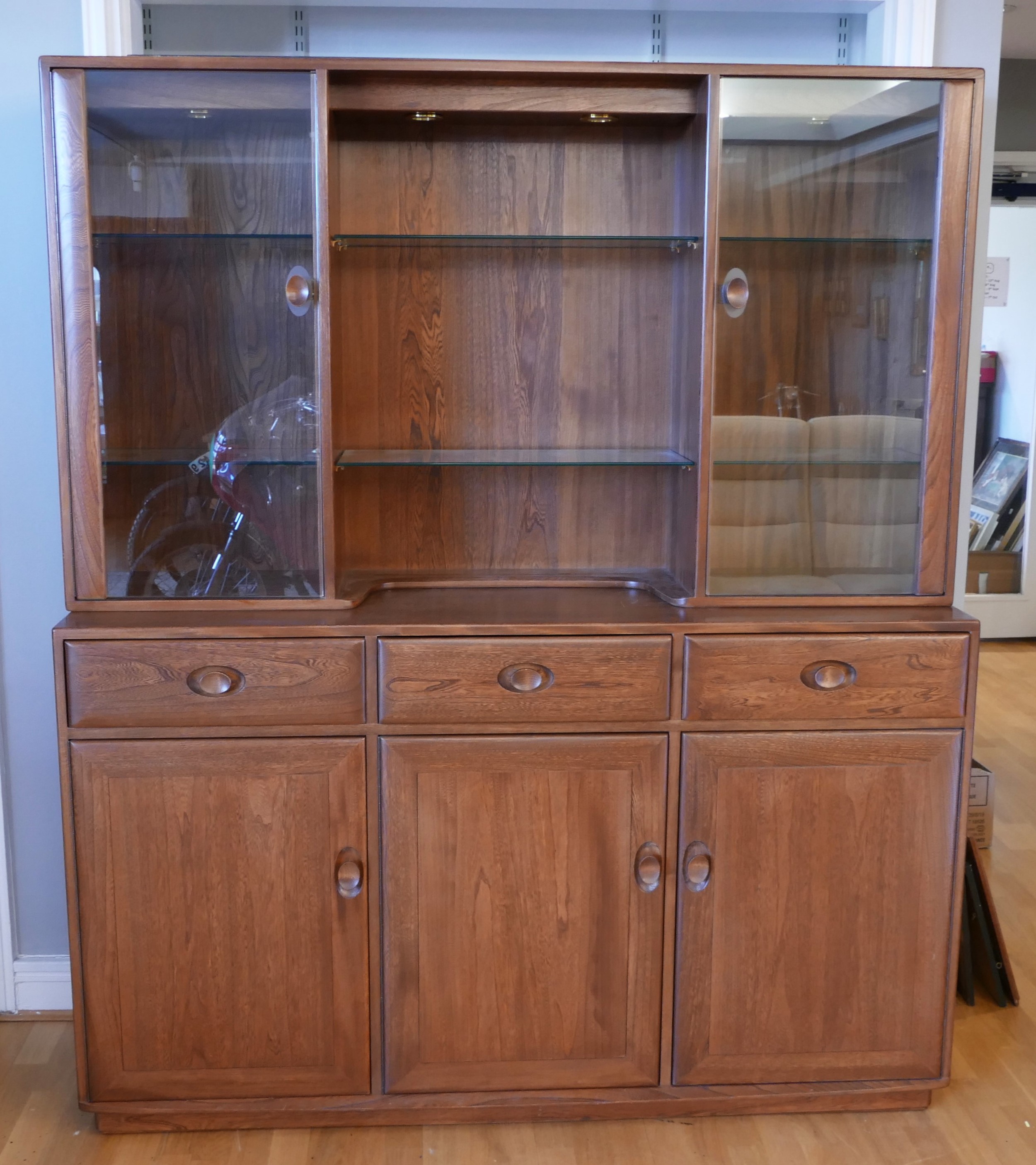 Ercol - elm display cabinet; two glazed doors flanking glass shelves ...