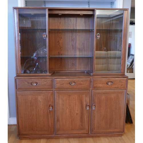 Ercol - elm display cabinet; two glazed doors flanking glass shelves with lighting above, the base u