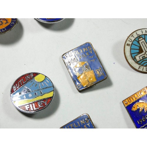 A collection of 17 Butlins metal and enamel badges, including Filey ...