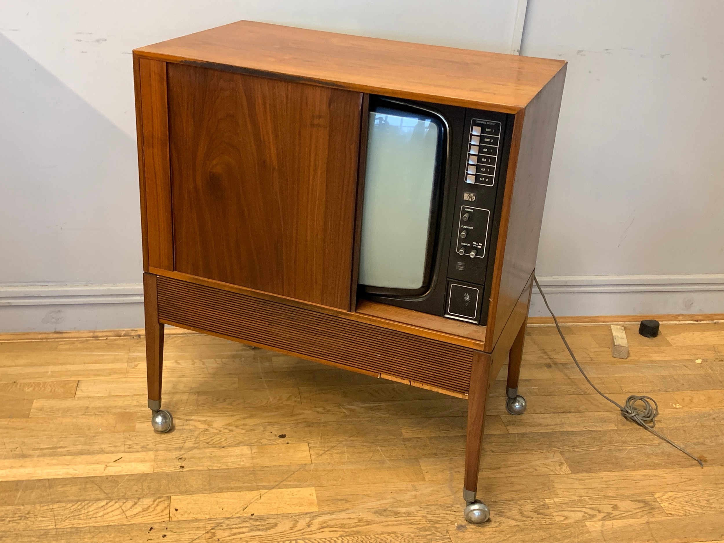 A PYE CRT Tv (Model CT22b series 741), in a teak case, on tapered legs ...