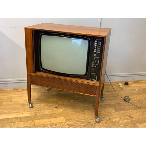 A PYE CRT Tv (Model CT22b series 741), in a teak case, on tapered legs ...
