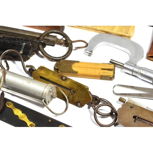 A collection of measuring devices, to include slide rules, calipers ...