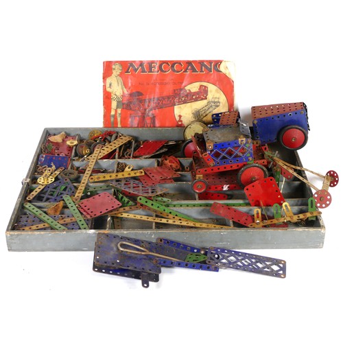 A quantity of early 20th century loose Meccano pieces and instruction ...
