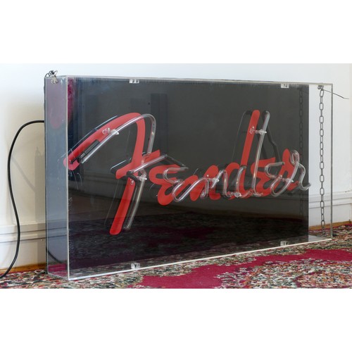 A Fender neon shop display sign, in a Perspex case, with chain hangers ...