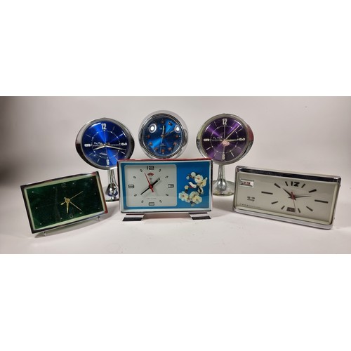 A Chinese Polaris alarm clock with bird amongst foliage, two other ...