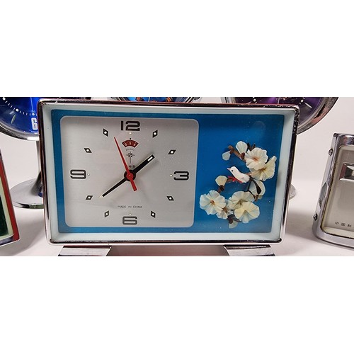 A Chinese Polaris alarm clock with bird amongst foliage, two other ...
