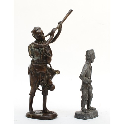 A bronze sculpture of an African hunter, 23cm tall, together with a ...