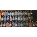 A collection of metal and enamel car key fobs