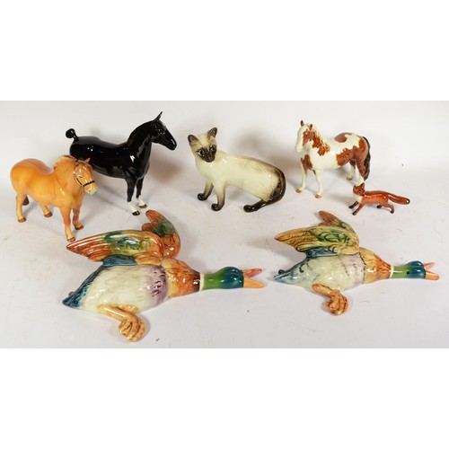 A collection of Beswick figures, to include three horses, a siamese cat ...