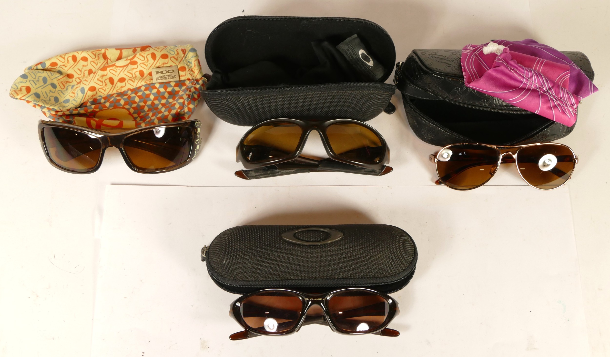 Four pairs of Oakley sunglasses.