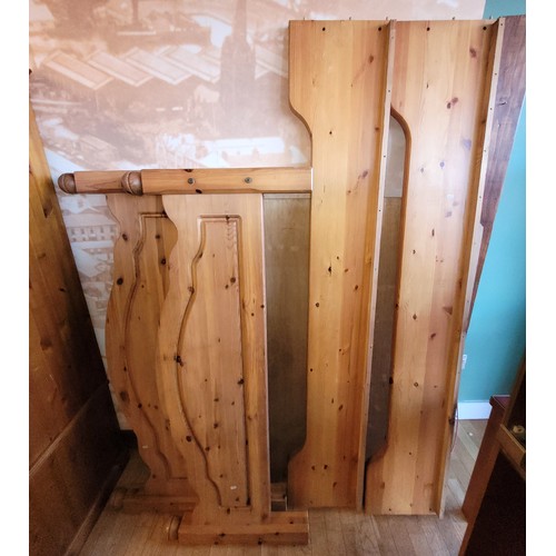 A modern pine triple wardrobe, three panelled doors over four long ...