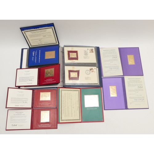 22ct Golden Replicas of British Stamps (13), album, and seven 23ct gold ...